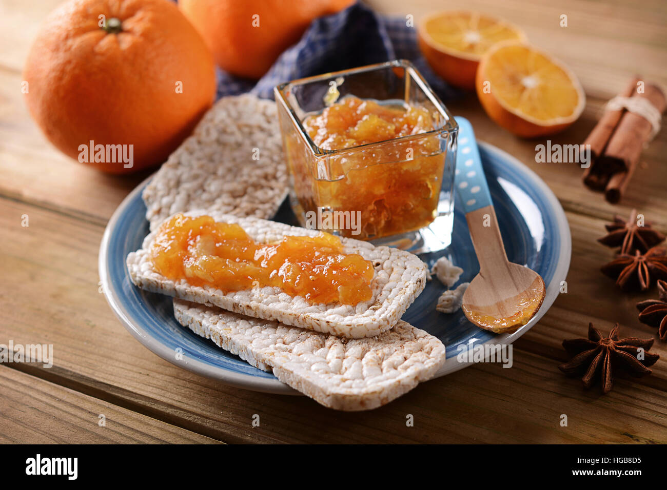 orange jam with cracker puffed rice on the blue plate Stock Photo - Alamy