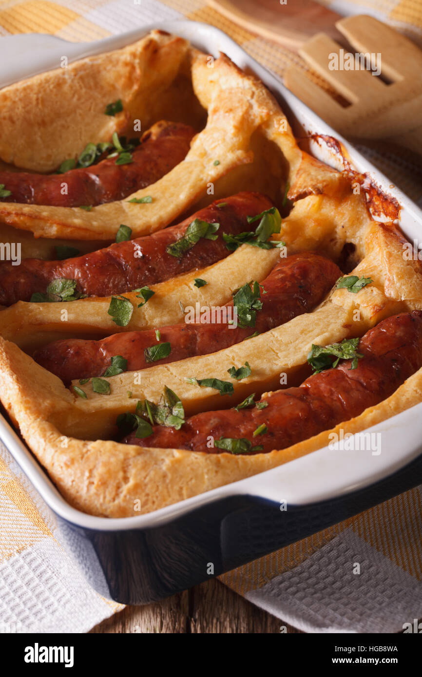 toad in the hole in baking dish close up on the table. Vertical Stock ...