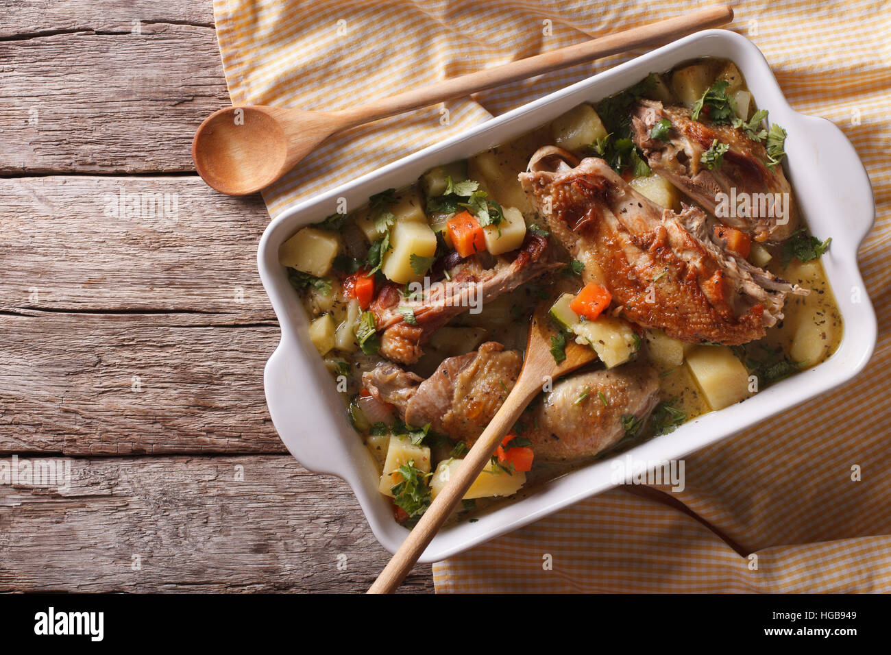 Pieces of chicken stewed with vegetables in a dish. Horizontal top view ...