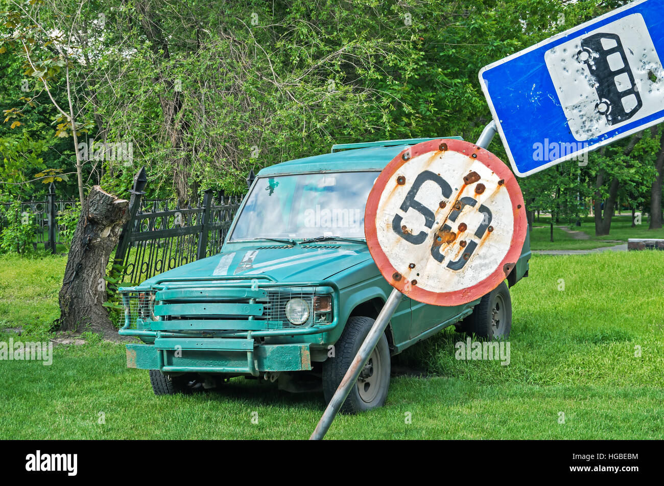 Damaged road signs on background old broken car Stock Photo - Alamy