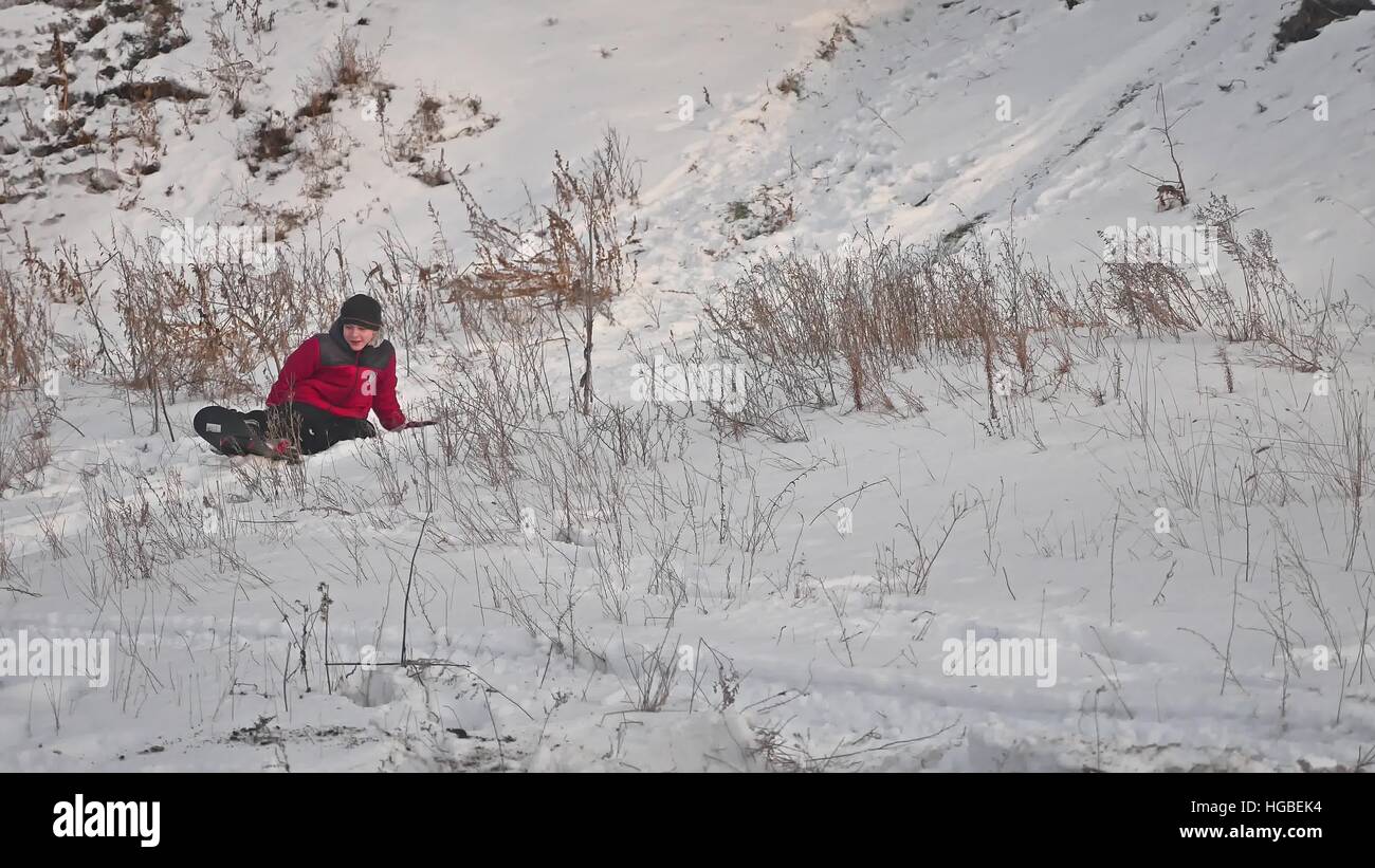 boy man snowboarding fall rolling in the snow with sport holidays ...