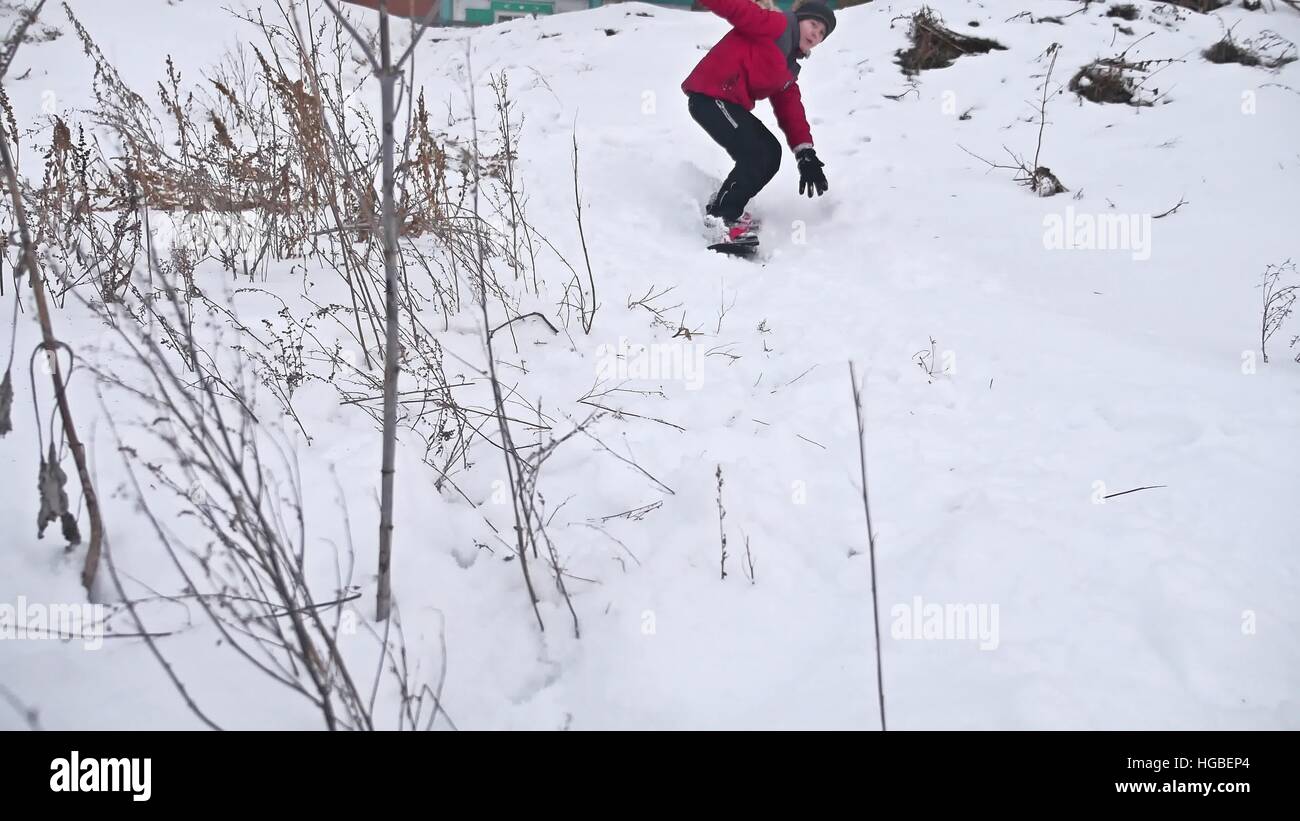 boy snowboarding fall rolling in the snow with holidays sport winter ...