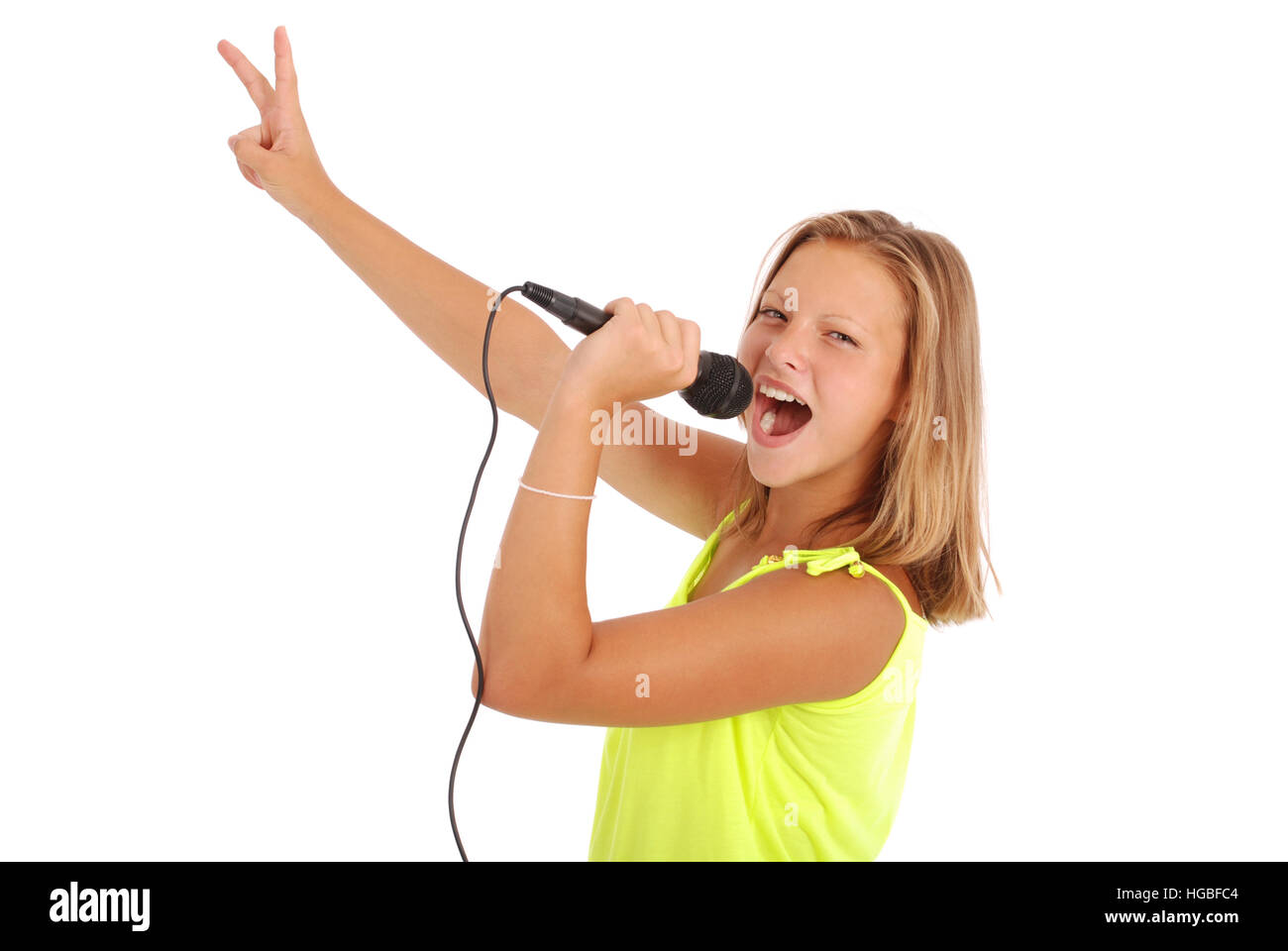 Happy young beautiful girl singing with microphone isolated on white ...
