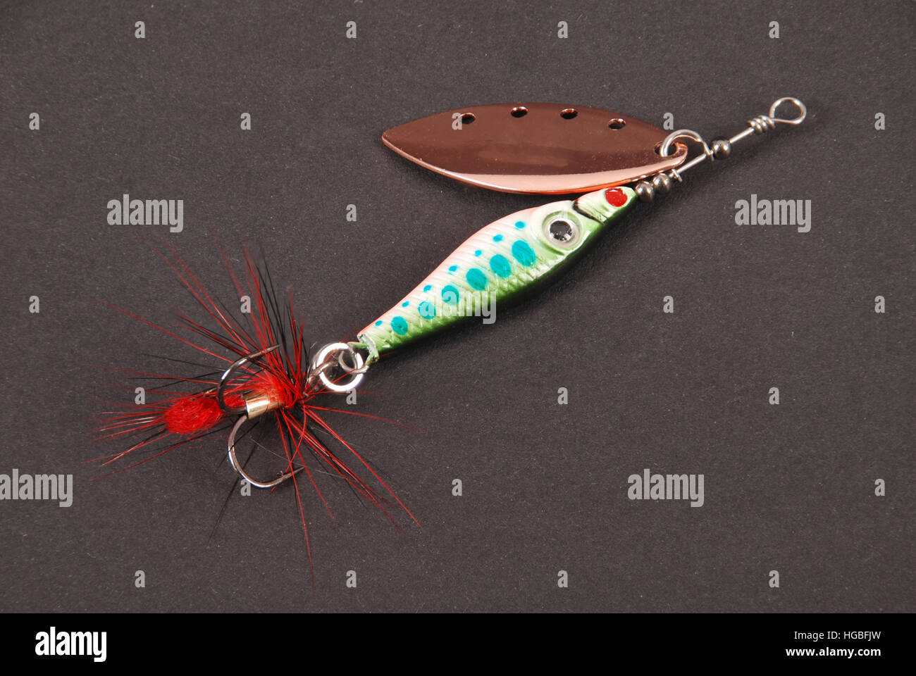 Fishing lure in the shape of a fish with a hook on gray background ...