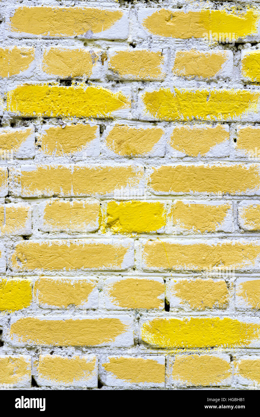 Painted yellow and white brick wall background Stock Photo - Alamy