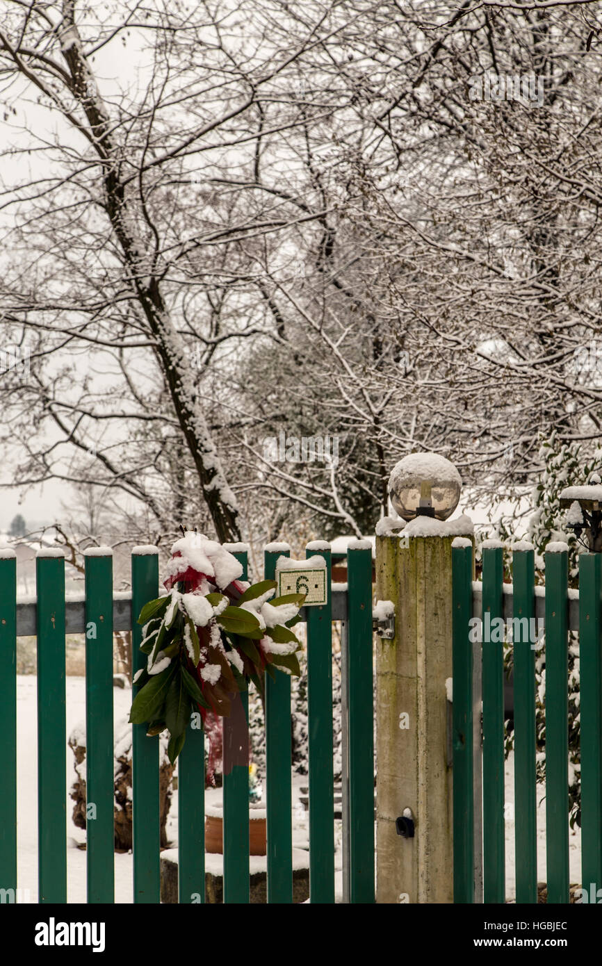 a gate covered with snow with a decoration for christmas Stock Photo ...