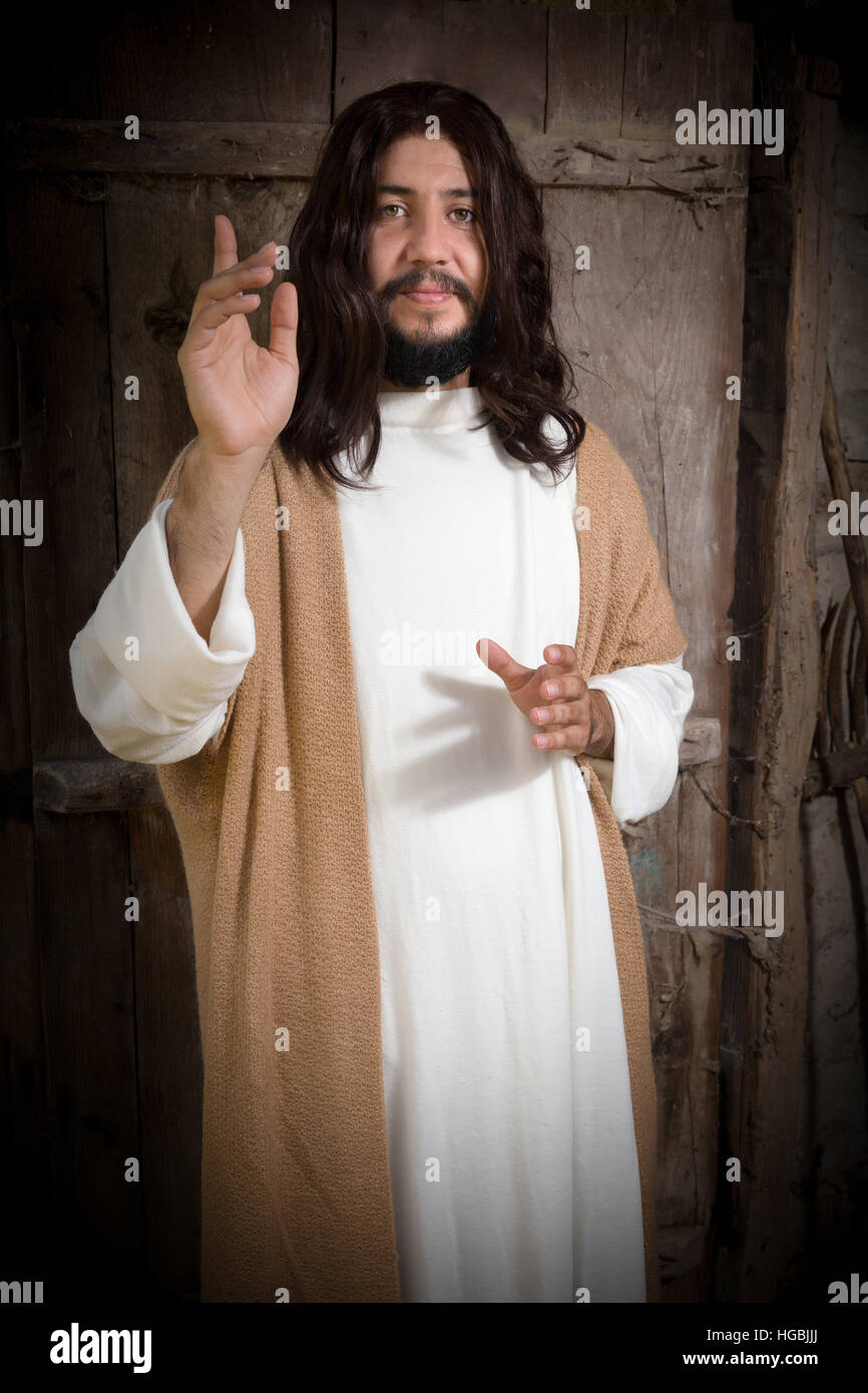 Portrait of a model in the role of Jesus Christ praying or preaching ...