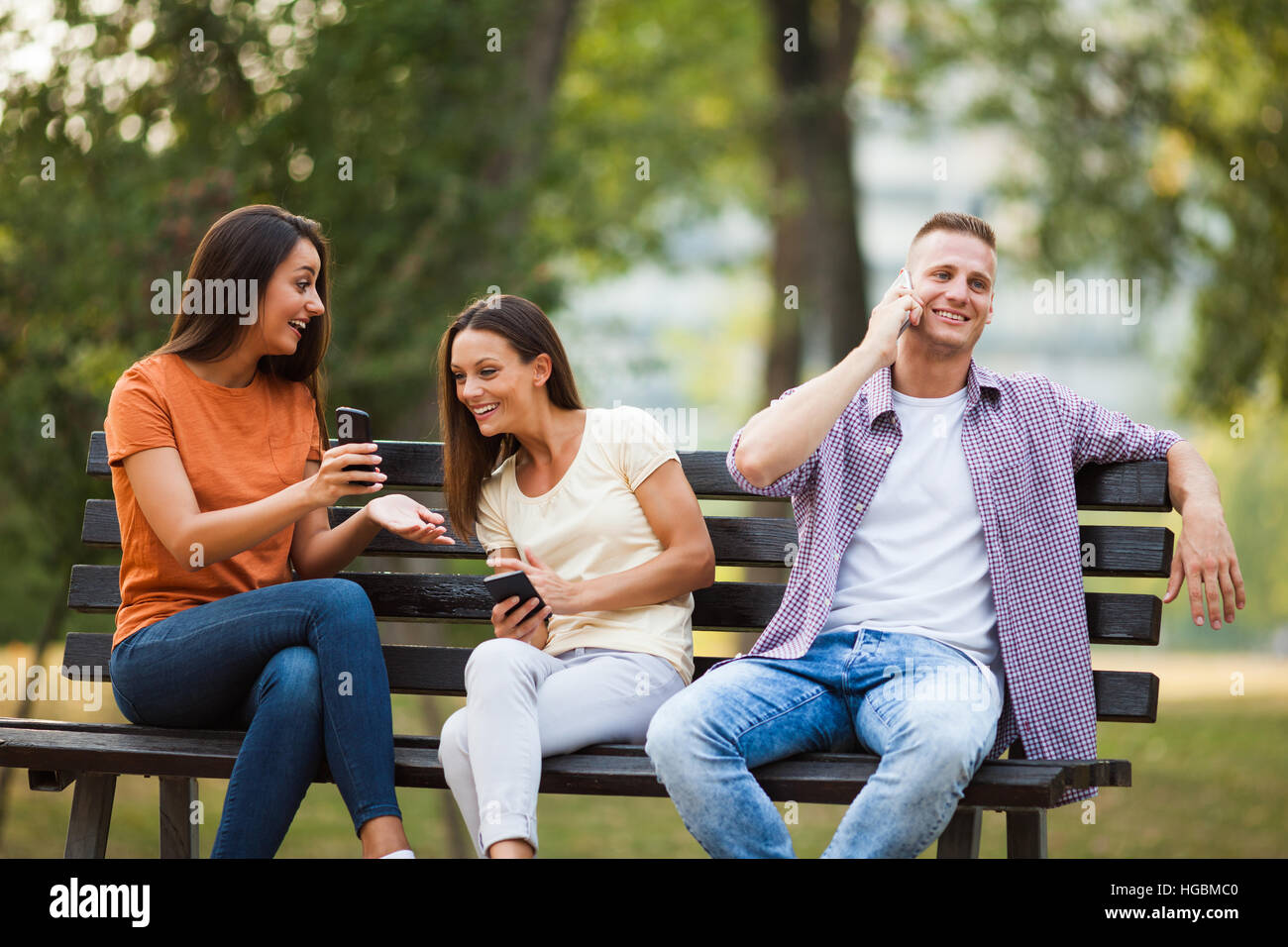 Friends in park Stock Photo - Alamy