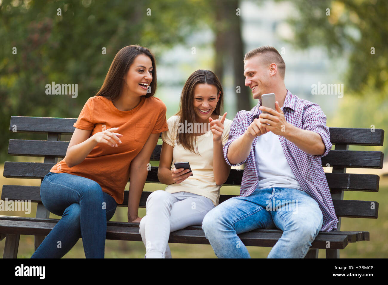 Friends in park Stock Photo - Alamy