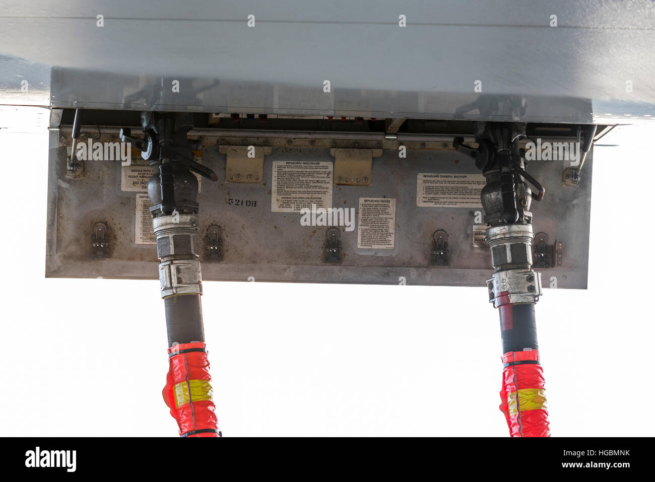 Aircraft refuelling panel. Fuel hoses connected to an underwing ...