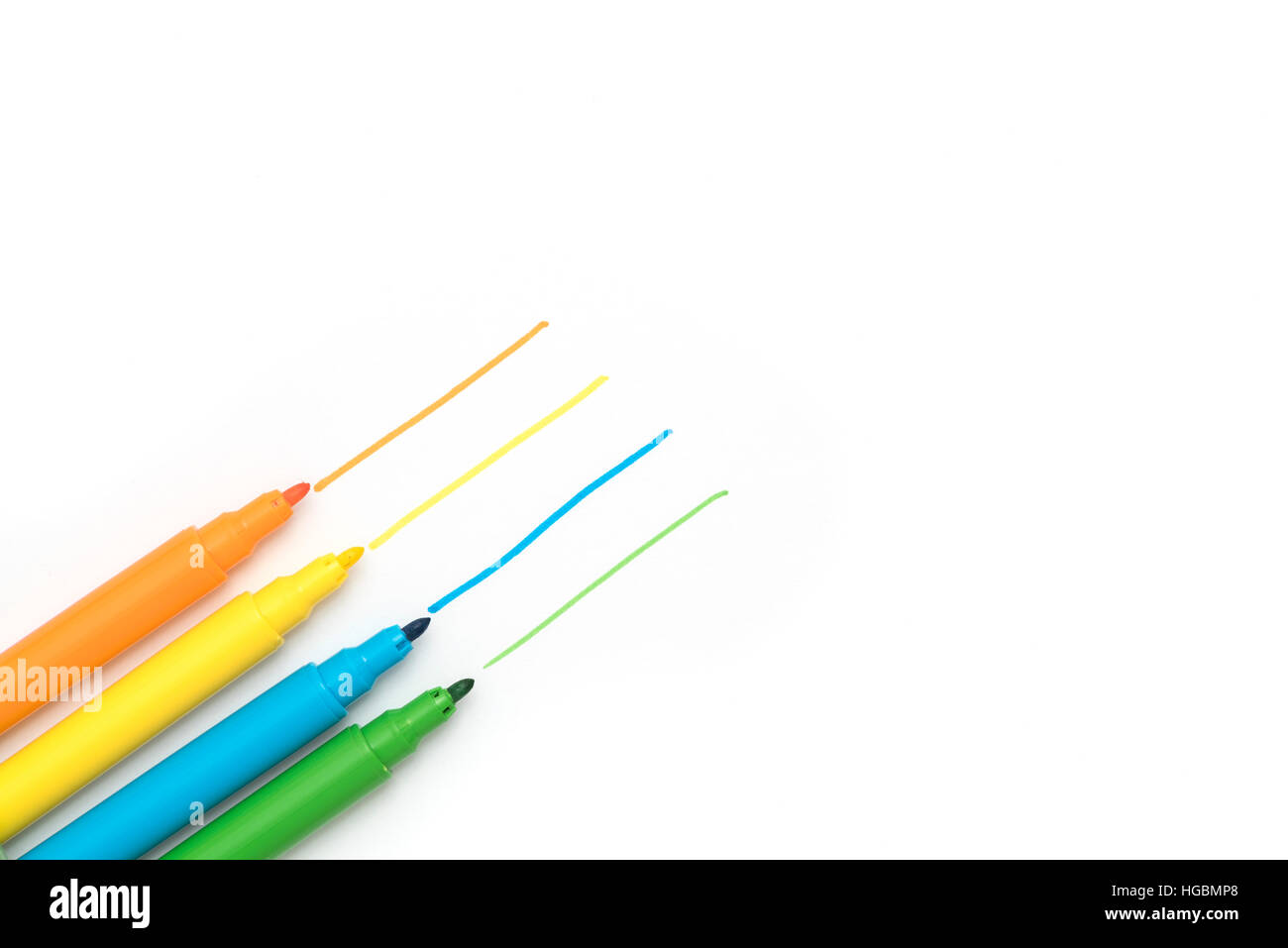 Coloring pens. Four coloured pens on white background with lines drawn ...
