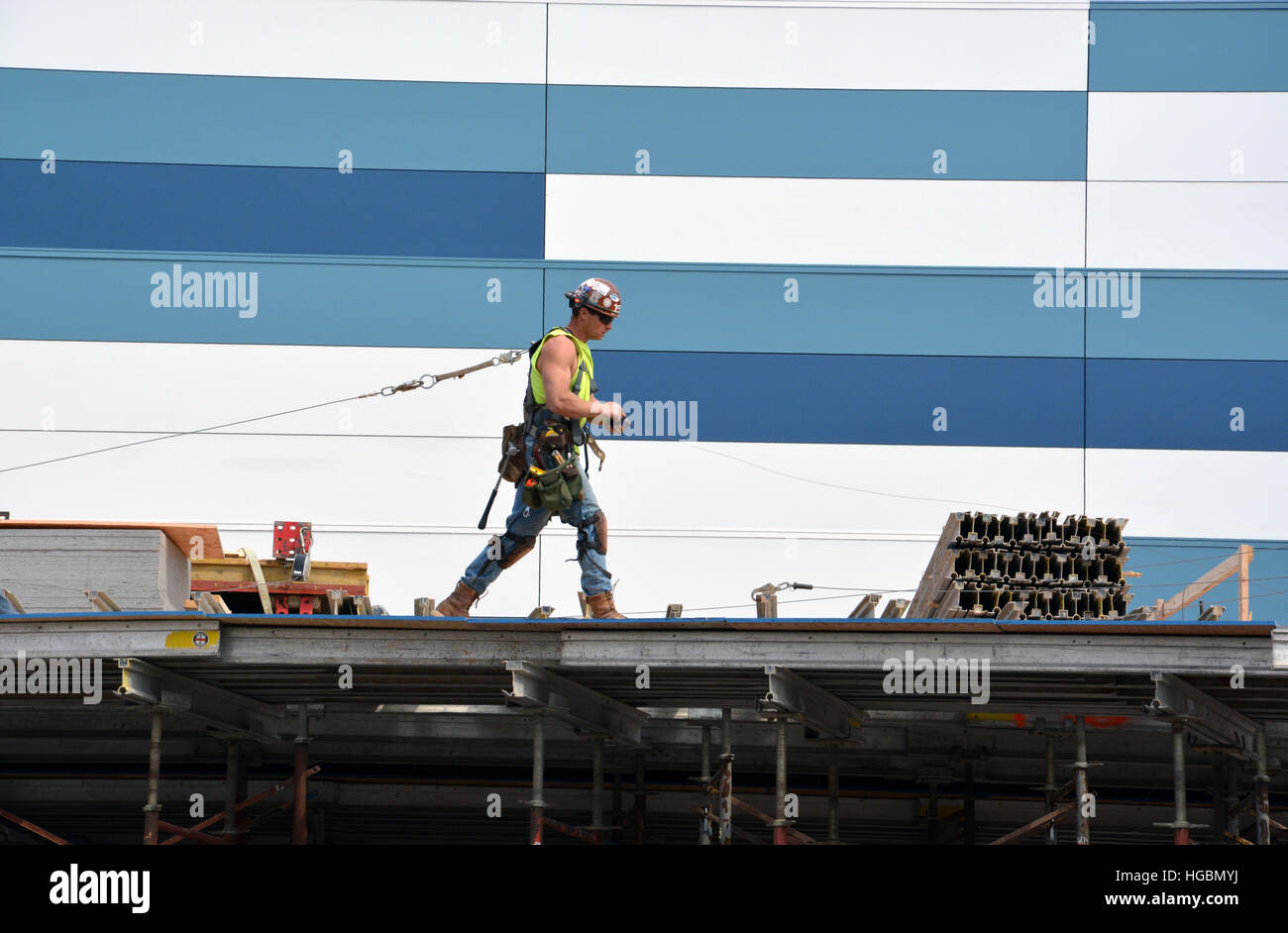 A construction worker helps ready the 2nd floor of a new building being ...