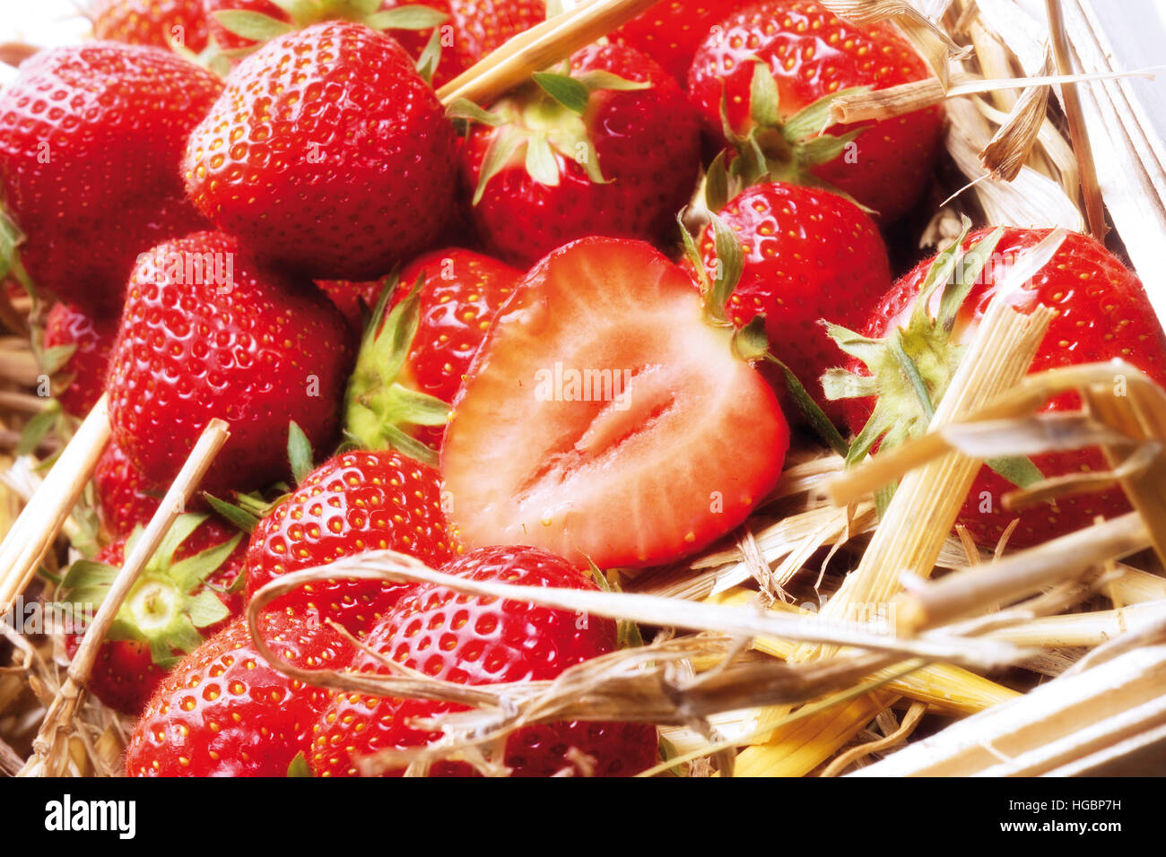 Strawberries laying in straw Stock Photo - Alamy