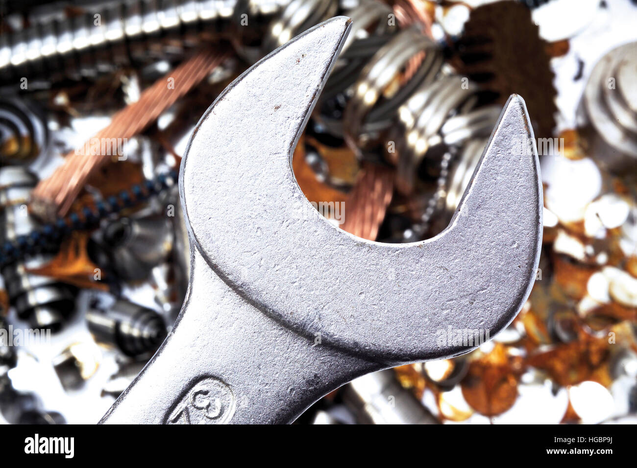 Open-end wrench with scrap metal in background Stock Photo - Alamy