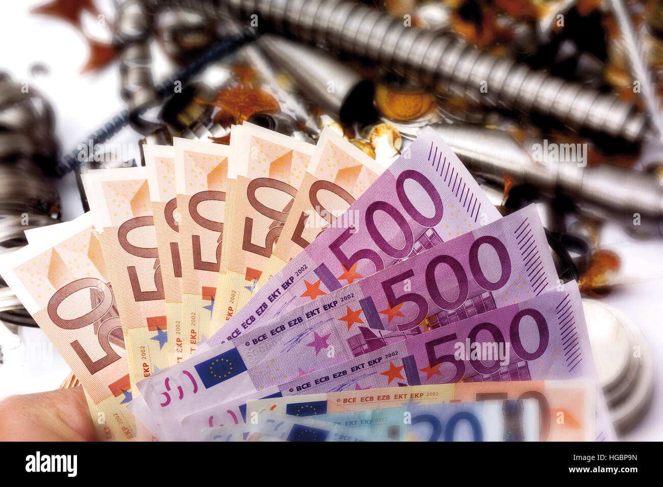 Euro notes with scrap metal in background Stock Photo - Alamy