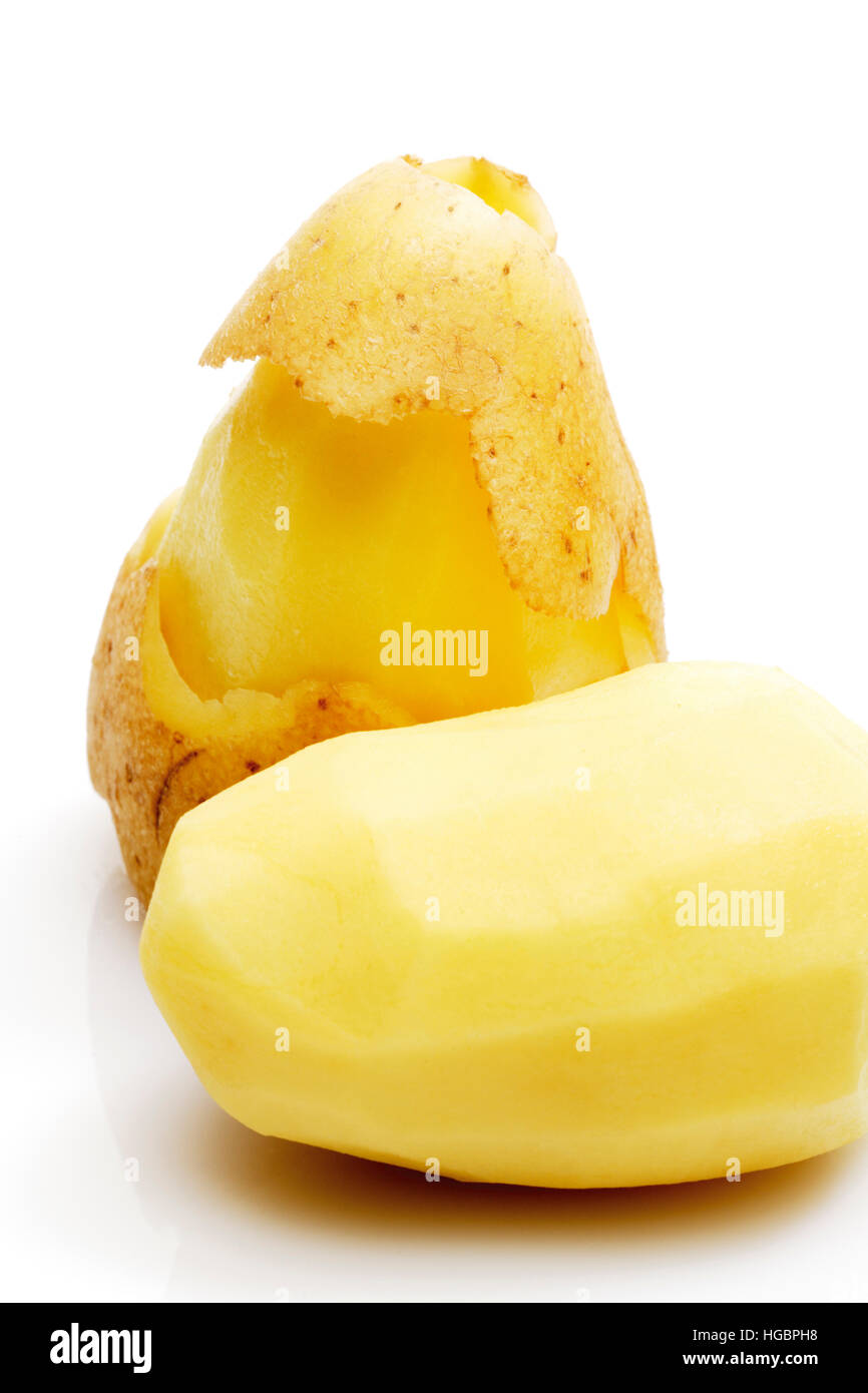 Raw potatoes, peeled and unpeeled Stock Photo - Alamy