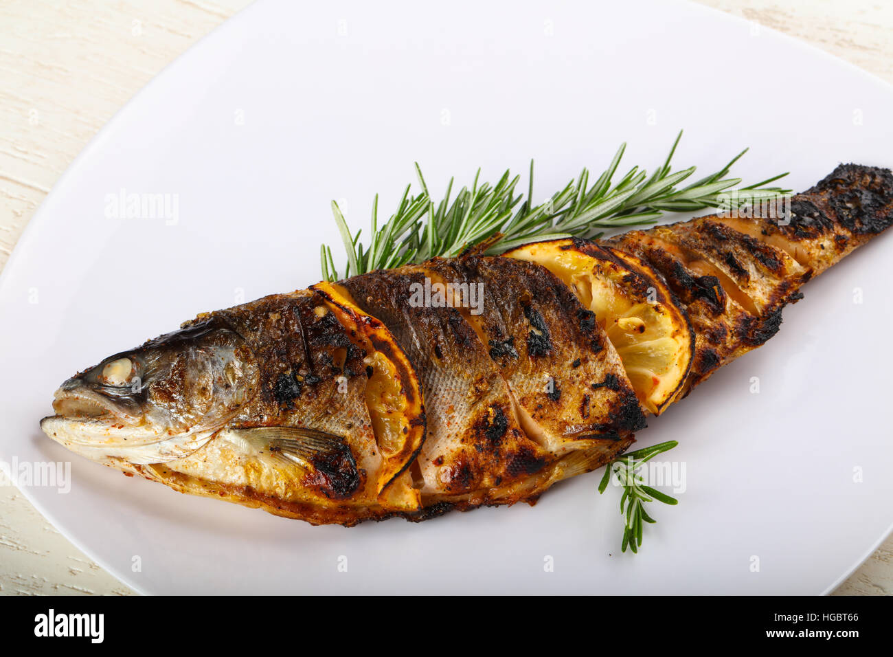 Hot fresh grilled trout with lemon and rosemary Stock Photo - Alamy