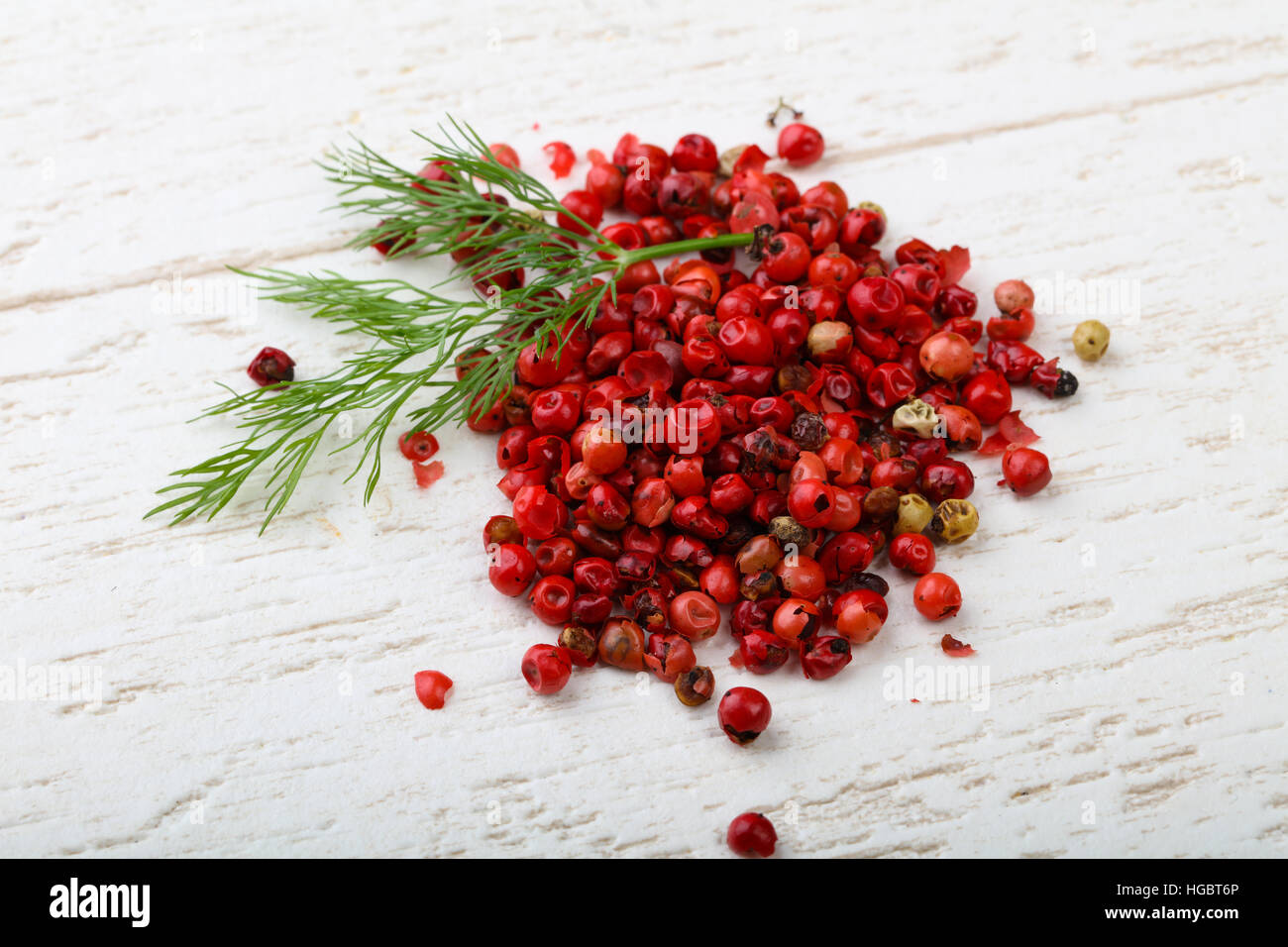 Red pepper corn on the wood background Stock Photo - Alamy