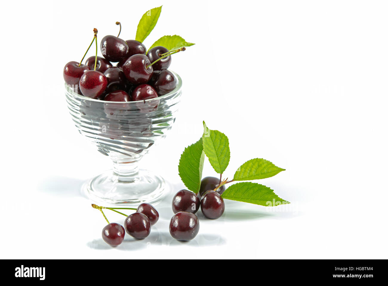 Beautiful cherries in a glass cup isolated on white background Stock ...