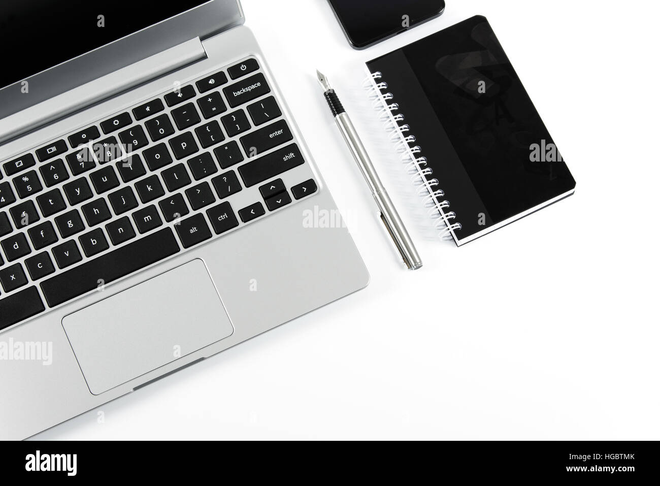 Elegant laptop and pen with notebook isolated on white background Stock ...