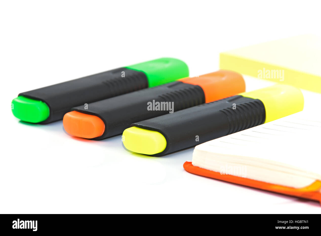 Markers in 3 colors and sticky notes with notepad on a white background ...