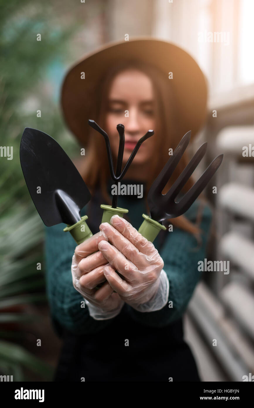 Young woman holding gardening tools hi-res stock photography and images ...