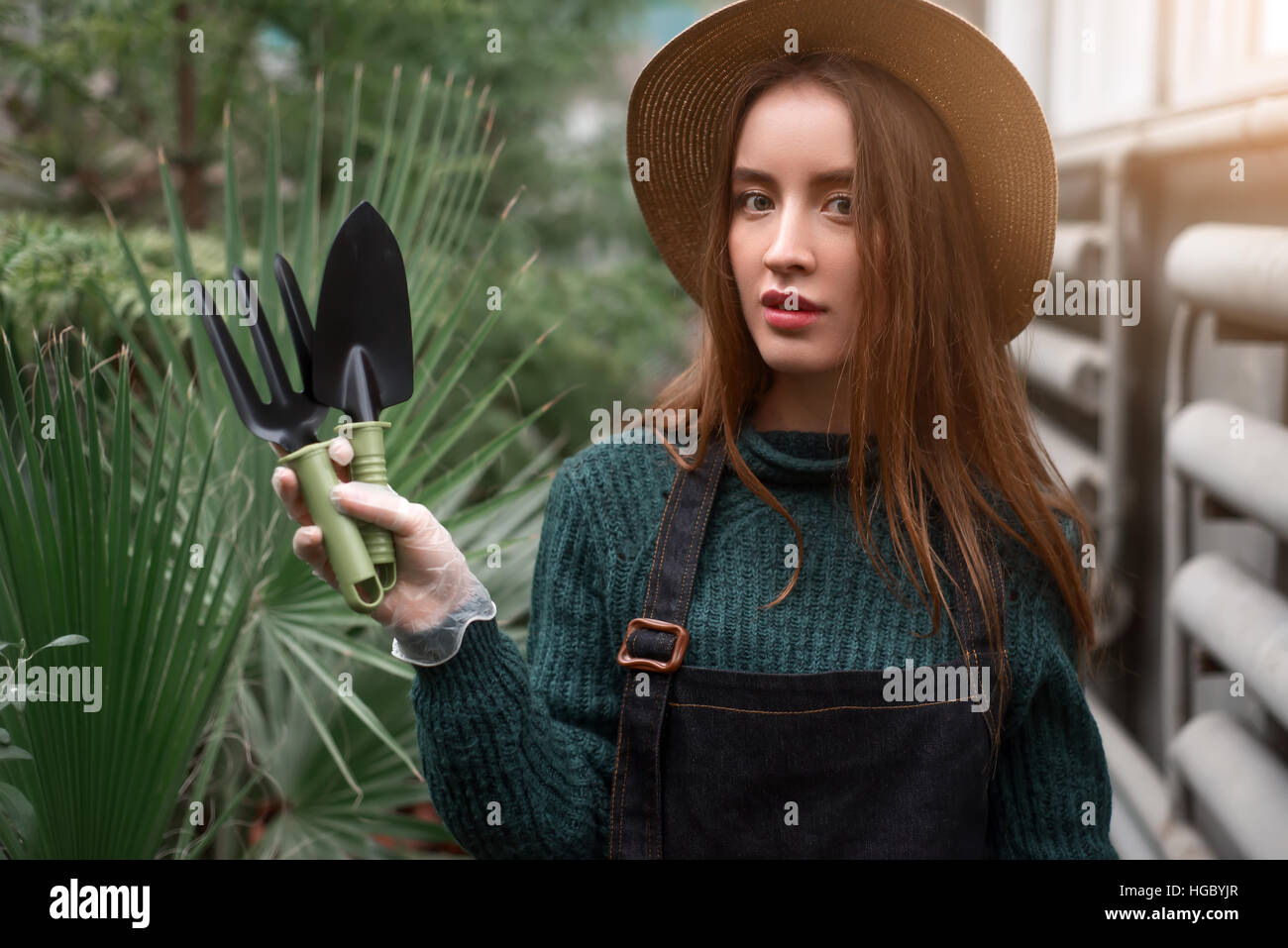 Gardener with garden tools in hands Stock Photo - Alamy