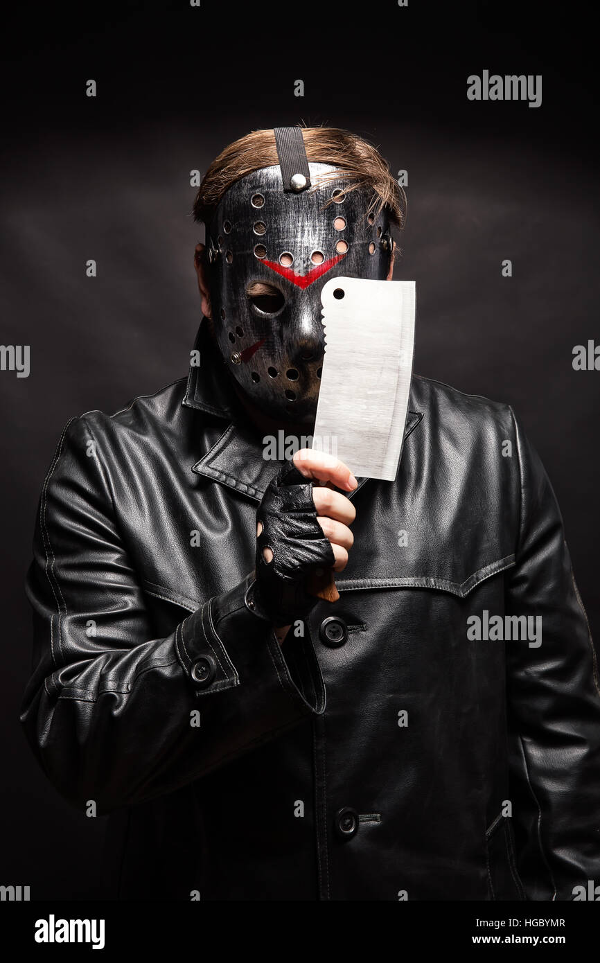 Serial murderer with knife on black background Stock Photo - Alamy