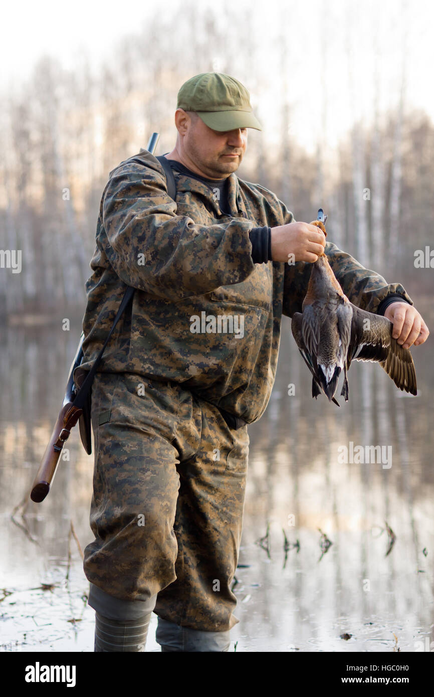 hunter holding a dead duck Stock Photo - Alamy