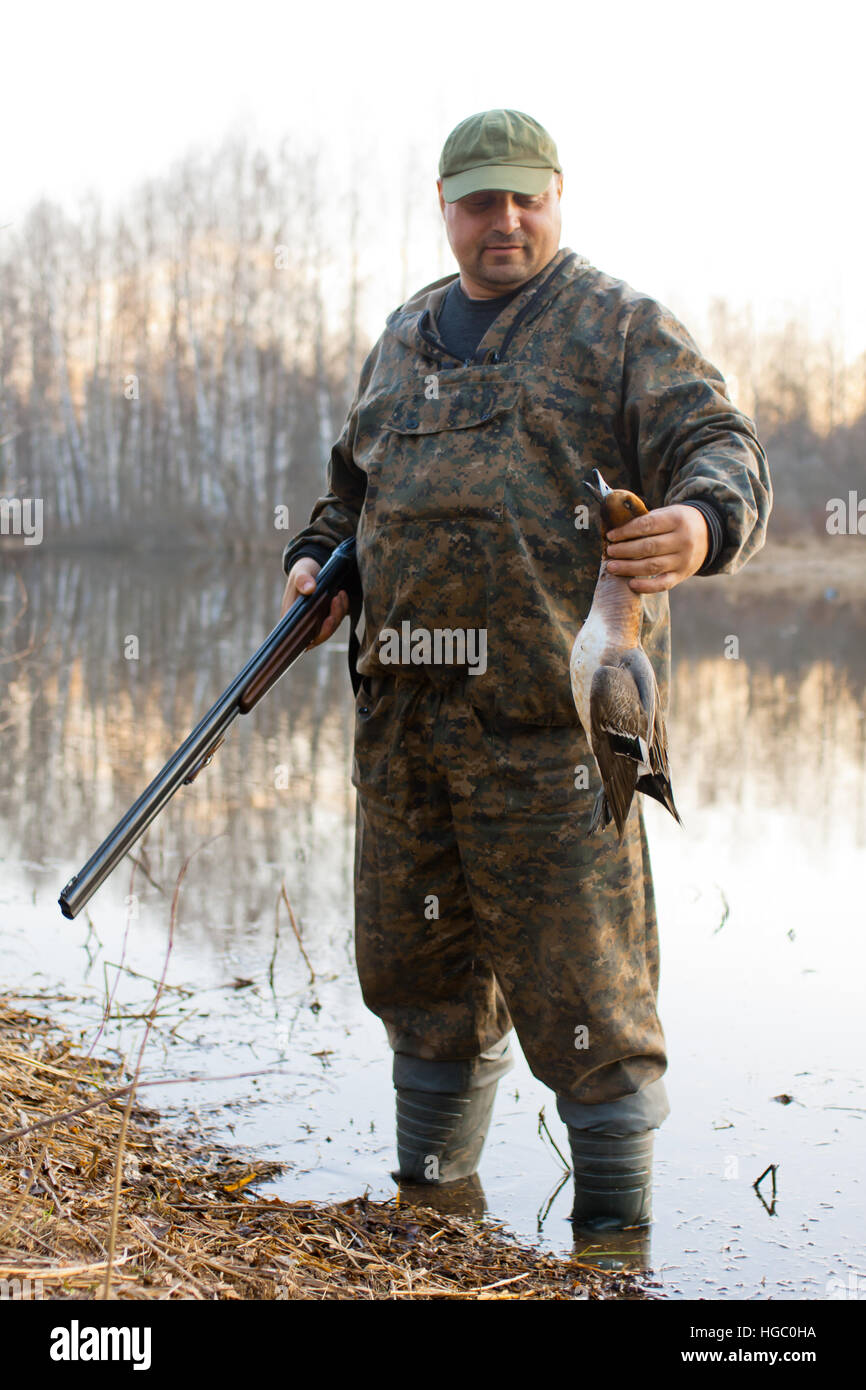 hunter with a dead duck Stock Photo - Alamy