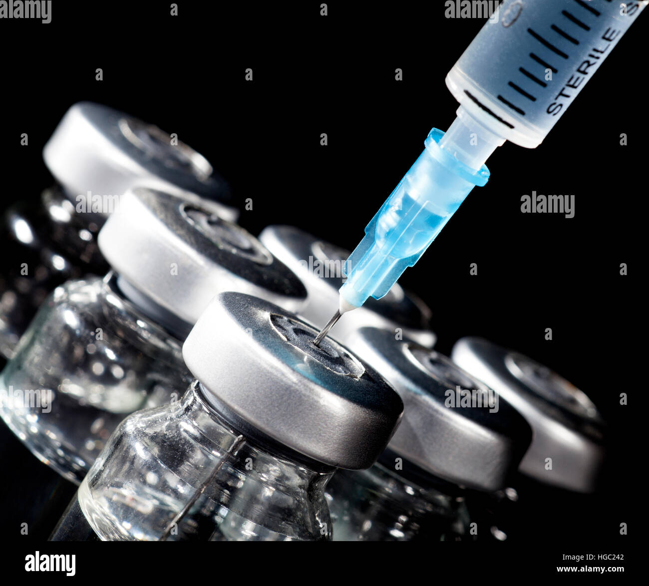 Glass Medicine Vials and Syringe on black background Stock Photo - Alamy