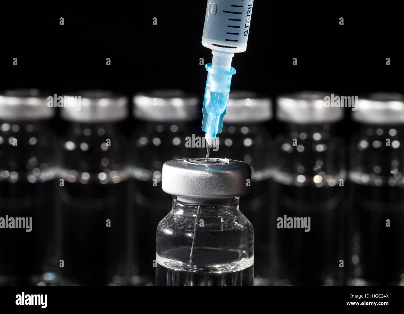 Glass Medicine Vials and Syringe on black background Stock Photo - Alamy