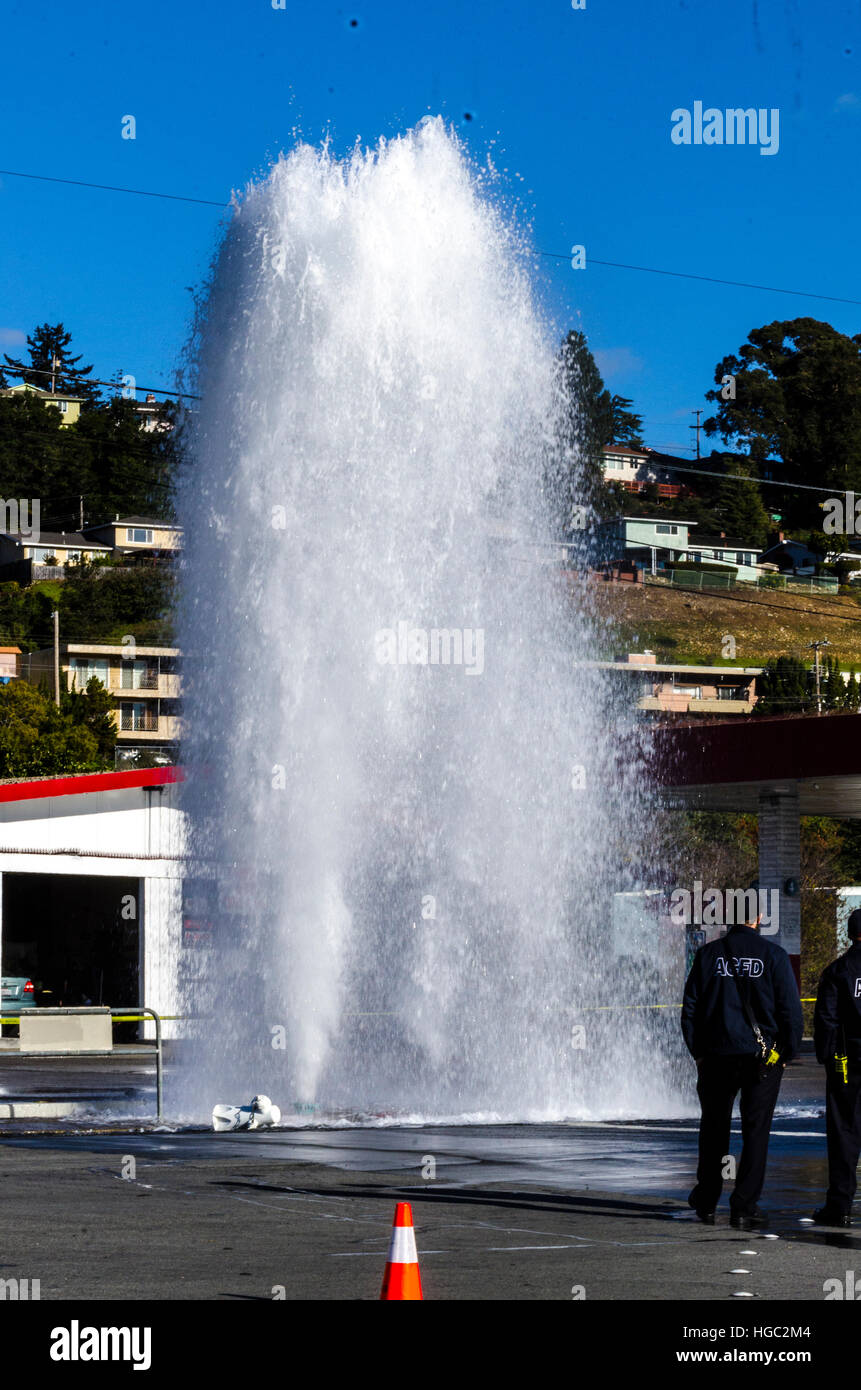 A fire hydrant broken off by a truck creates a geyser and small flood ...