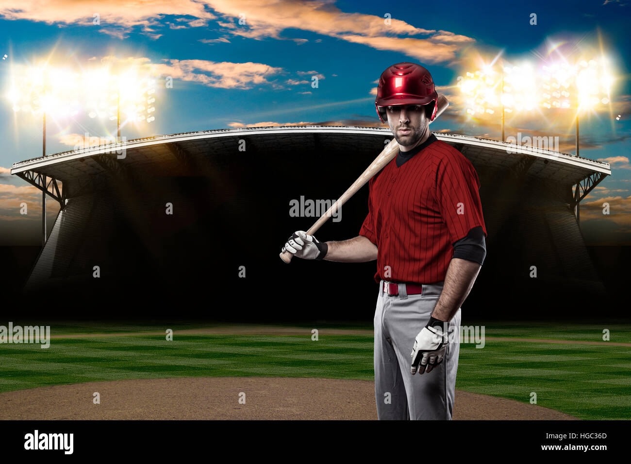 Baseball Player with a red uniform on baseball Stadium Stock Photo - Alamy