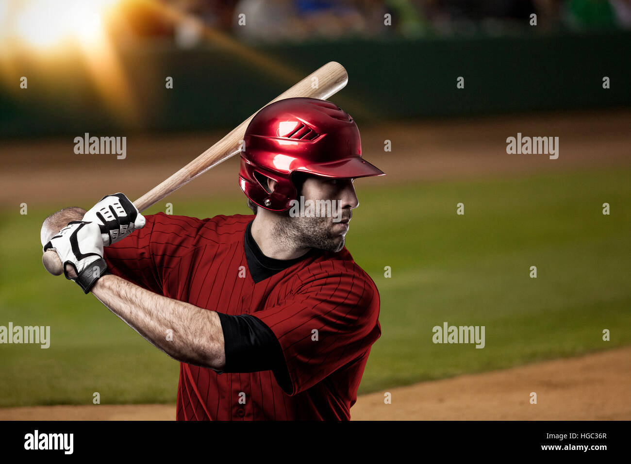 Baseball Player with a red uniform on baseball Stadium Stock Photo - Alamy