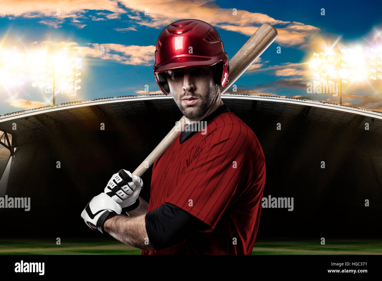 Baseball Player with a red uniform on baseball Stadium Stock Photo - Alamy