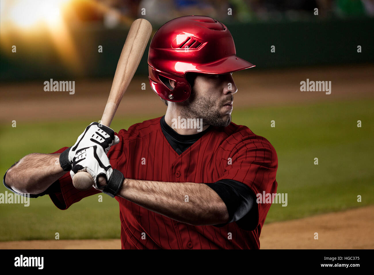 Baseball Player with a red uniform on baseball Stadium Stock Photo - Alamy