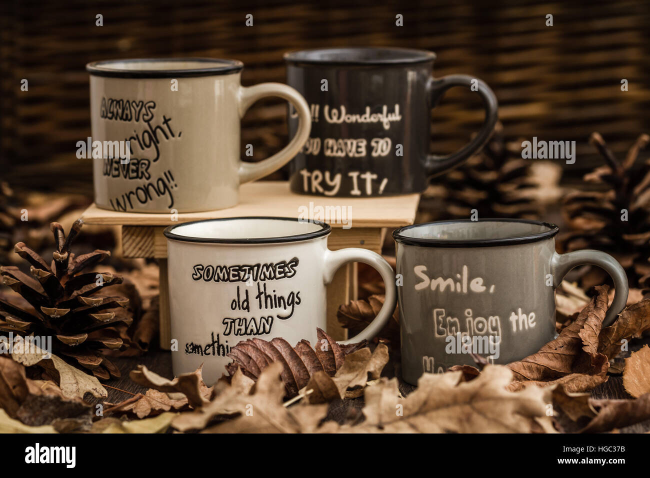 Creative coffee mugs with text on a background created by leaves Stock ...