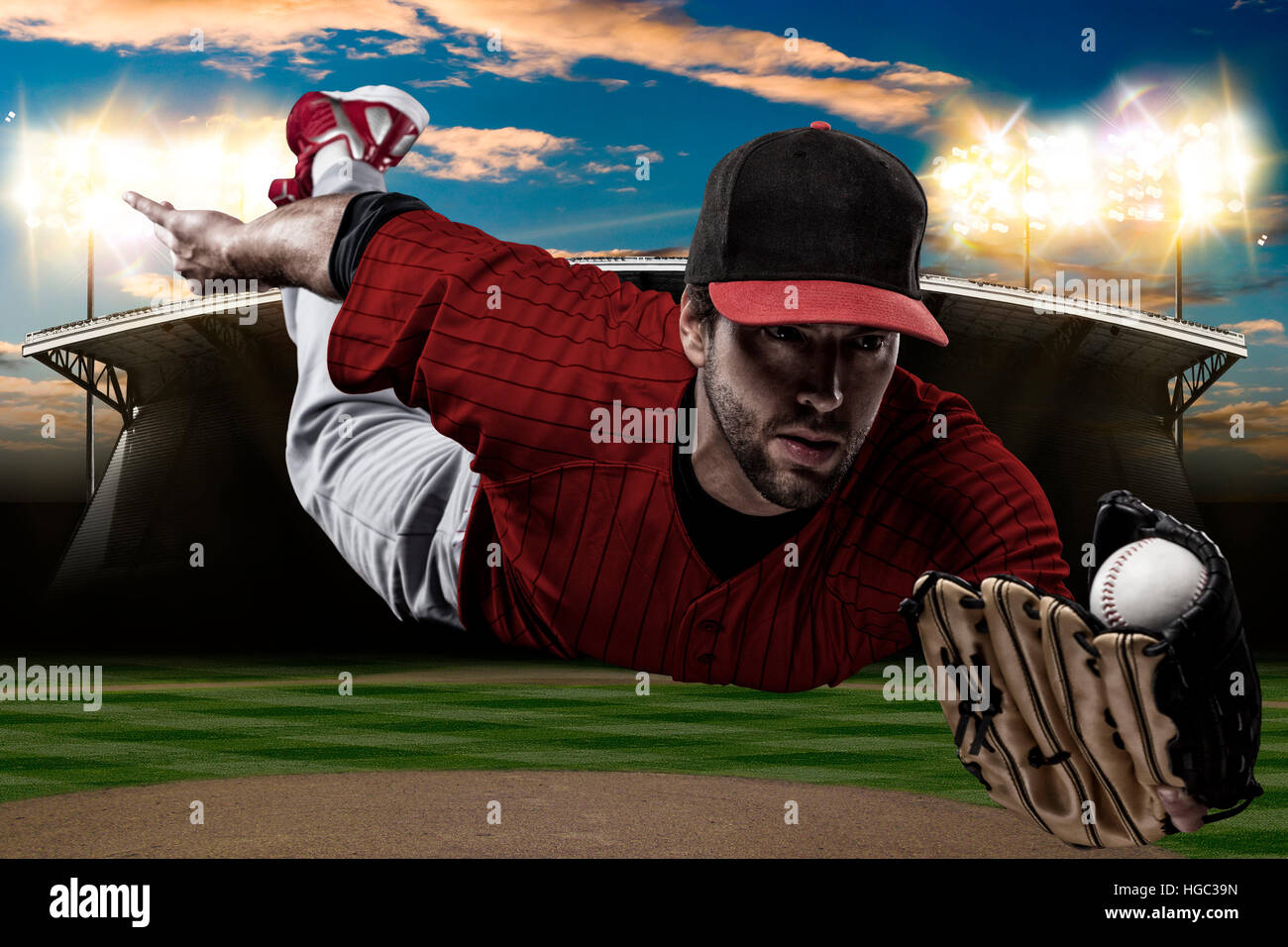 Baseball Player with a red uniform on baseball Stadium Stock Photo - Alamy
