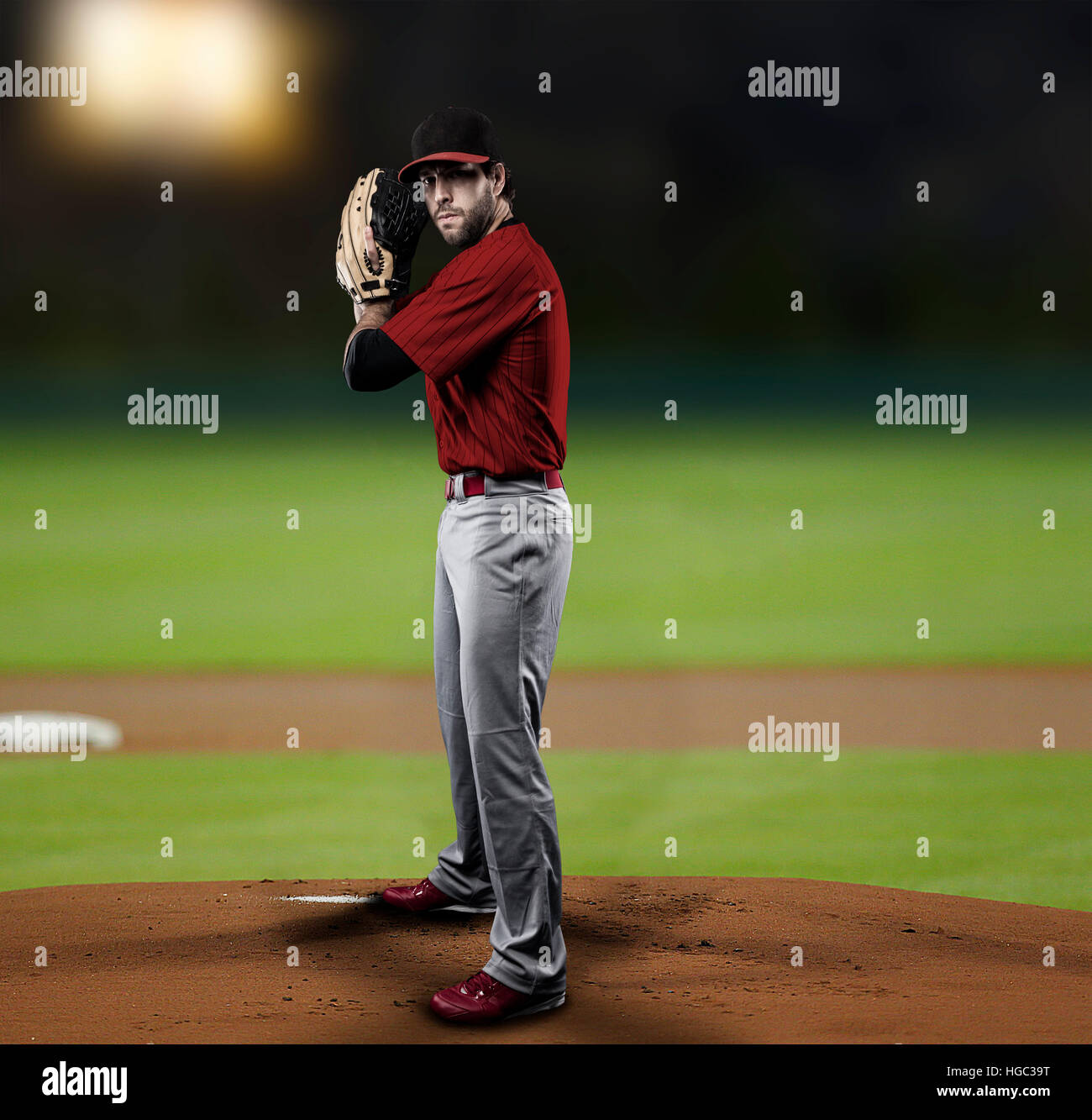 Pitcher Baseball Player with a red uniform on baseball Stadium Stock ...