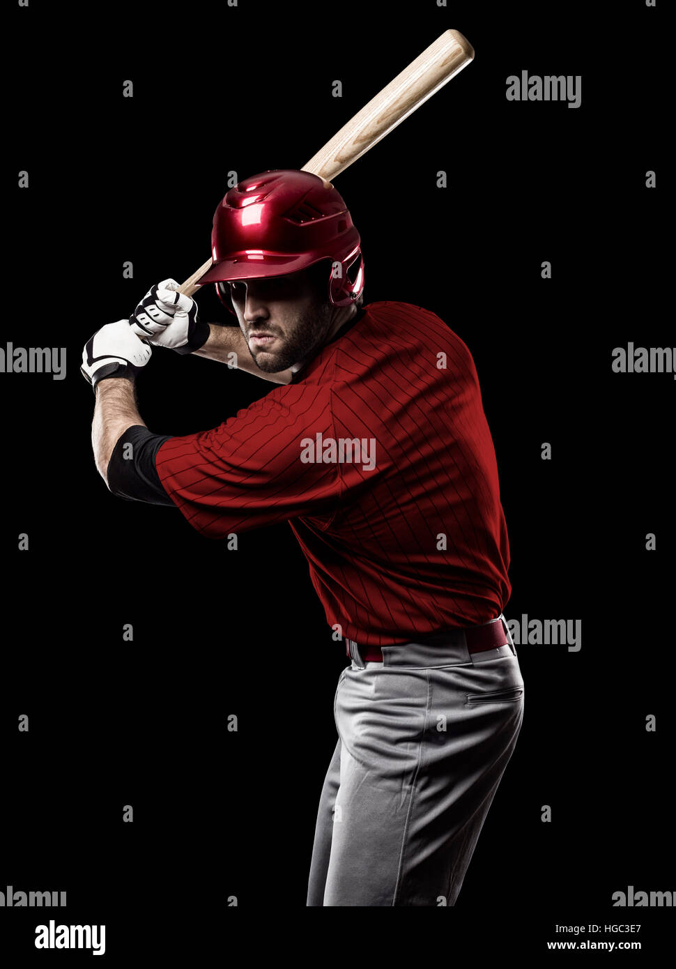 Baseball Player with a red uniform on a black background Stock Photo ...