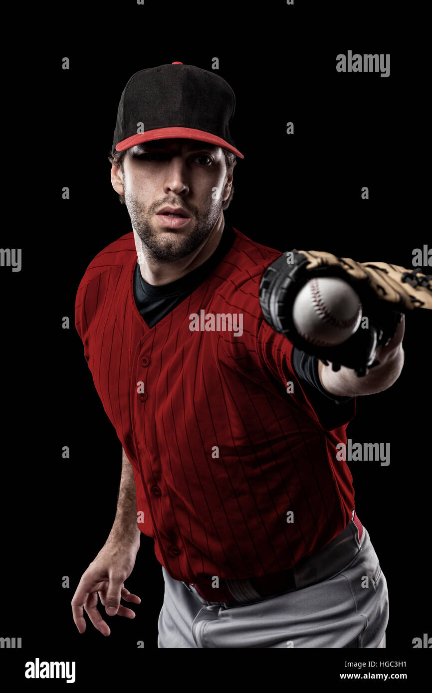 Baseball Player with a red uniform on a black background Stock Photo ...