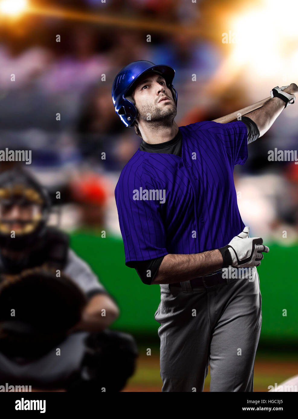 Baseball Player with a blue uniform on baseball Stadium Stock Photo - Alamy