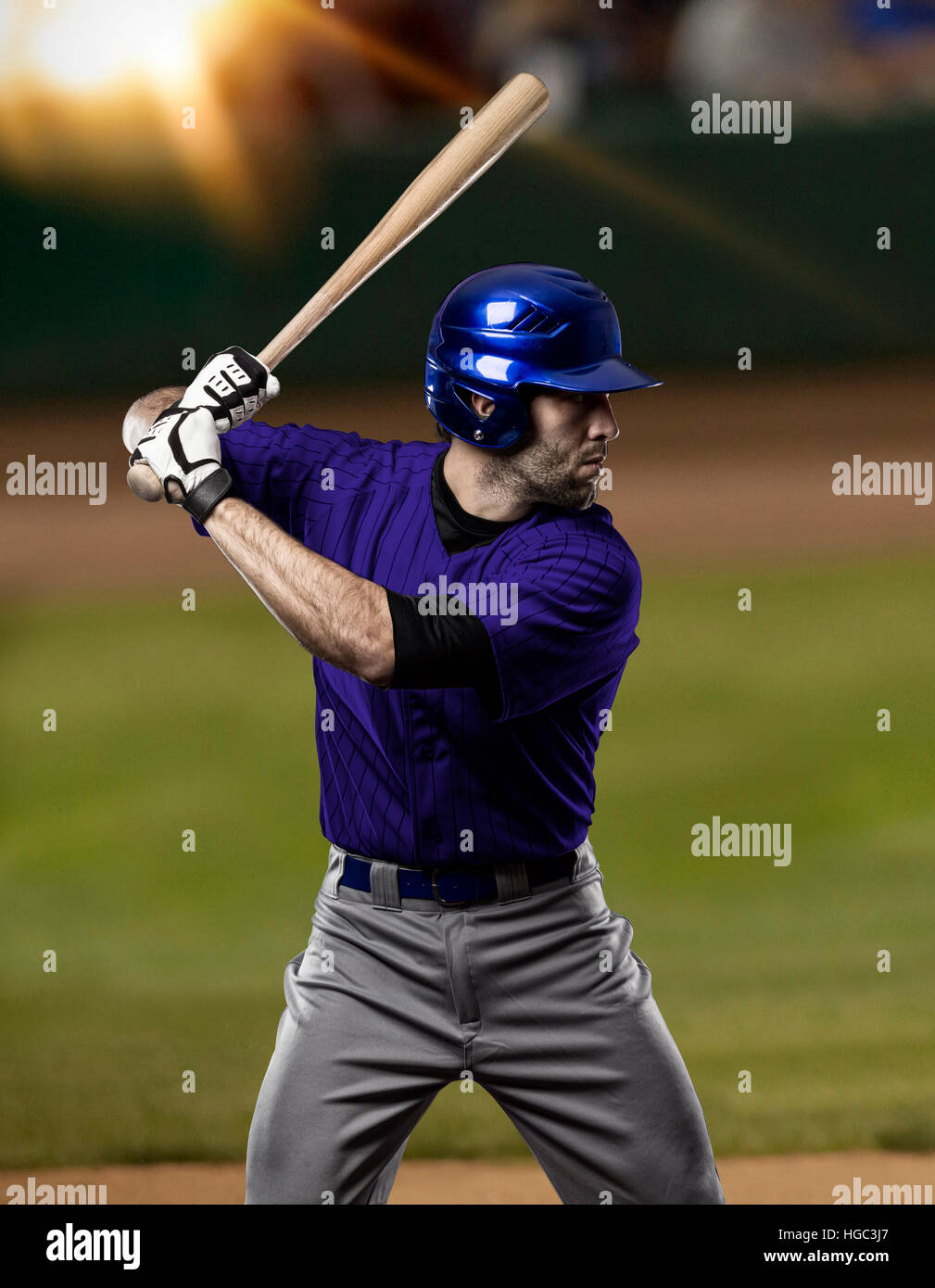 Baseball Player with a blue uniform on baseball Stadium Stock Photo - Alamy