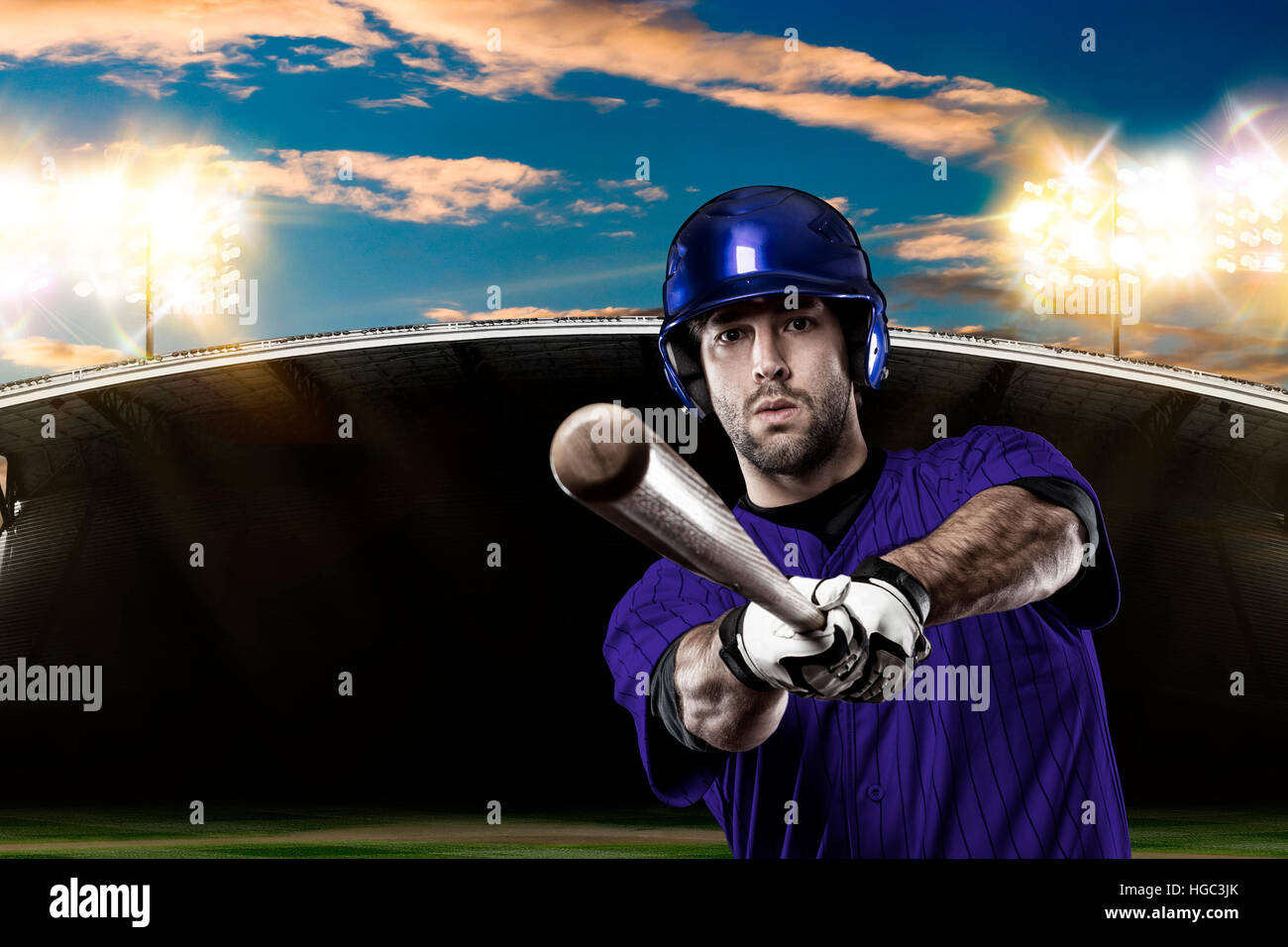 Baseball Player with a blue uniform on baseball Stadium Stock Photo - Alamy