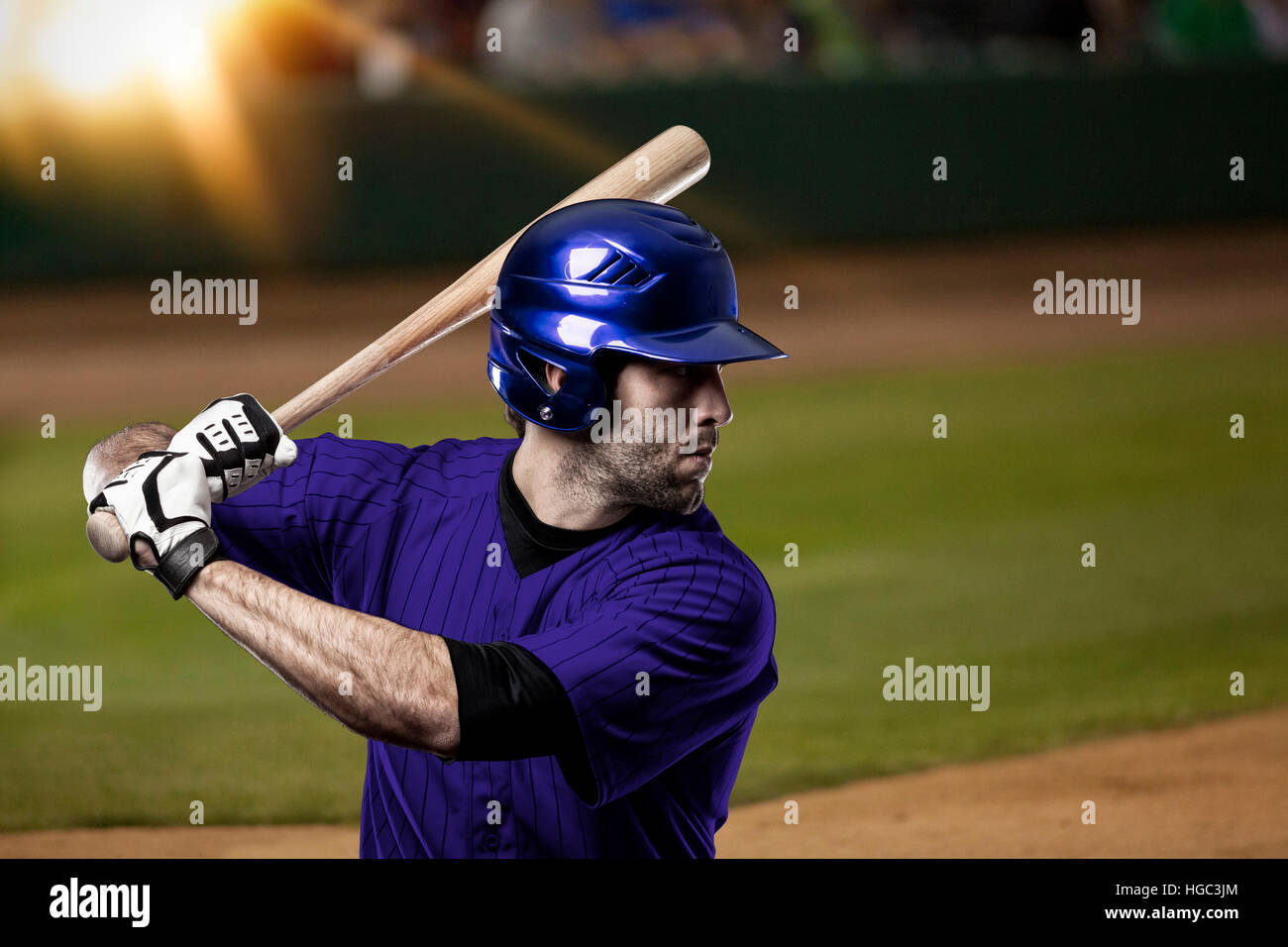 Baseball Player with a blue uniform on baseball Stadium Stock Photo - Alamy
