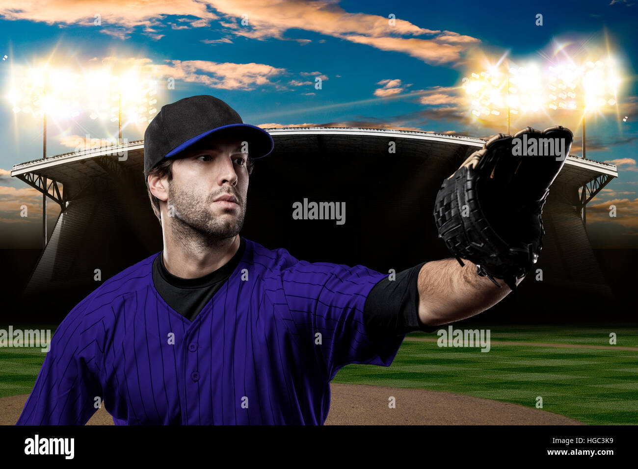 Baseball Player with a blue uniform on baseball Stadium Stock Photo - Alamy