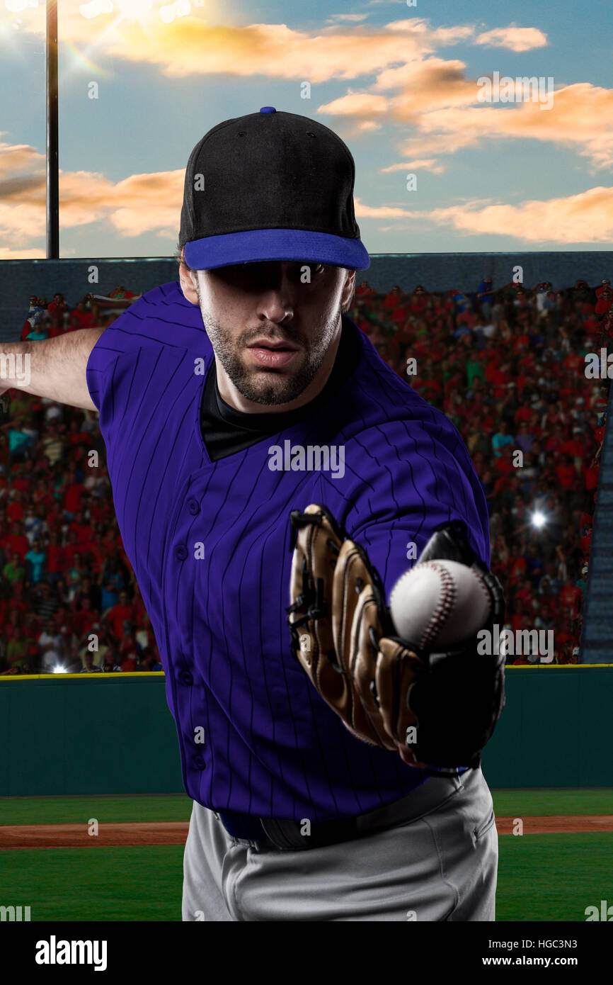 Baseball Player with a blue uniform on baseball Stadium Stock Photo - Alamy