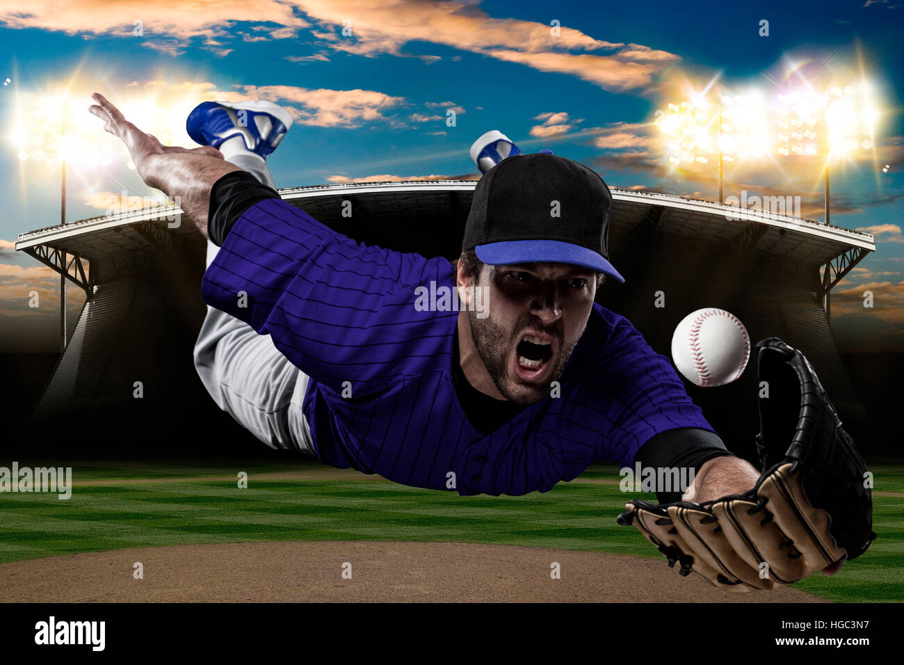 Baseball Player with a blue uniform on baseball Stadium Stock Photo - Alamy