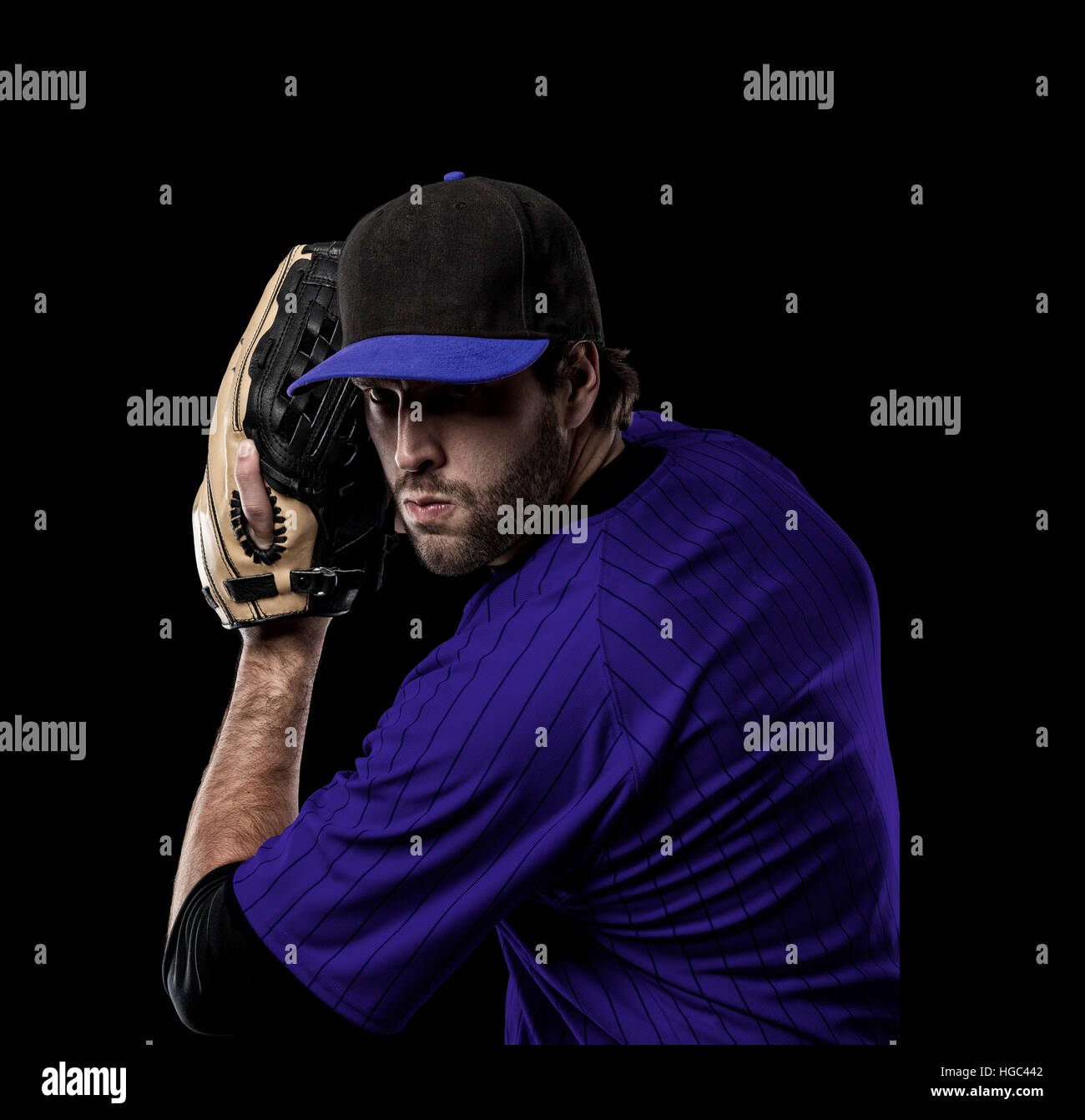 Pitcher Baseball Player with a blue uniform on a black background Stock ...